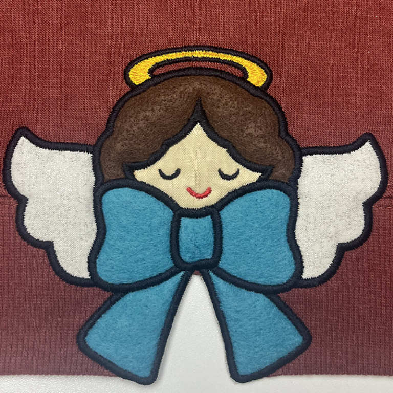 In The Hoop: Angel Bow Side Seam Applique – 2 sizes | Legacy